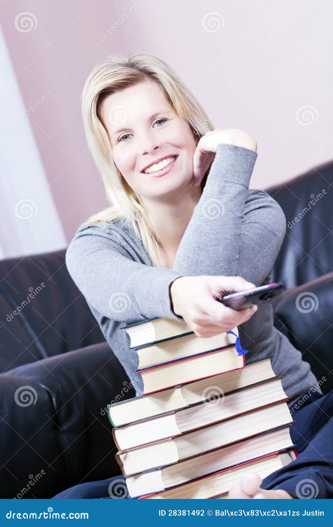 Beautiful Blond Girl Holding Remote Control. Stock Photo - Image of ...