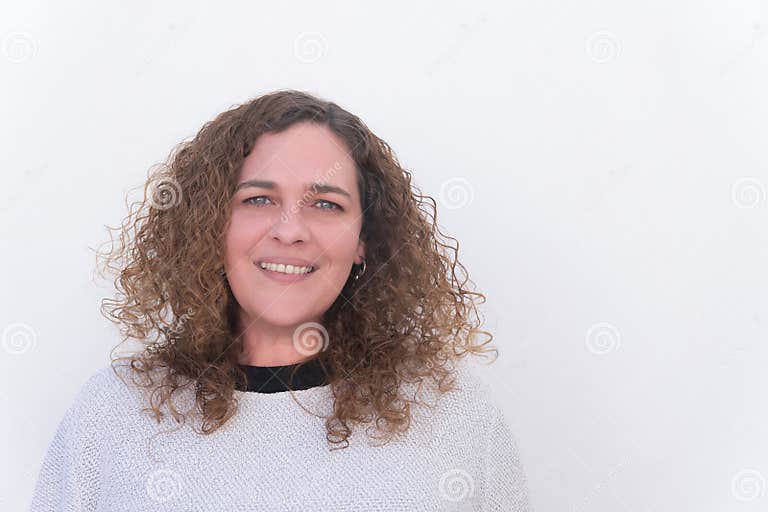 Beautiful Blond Woman With Curly Hair And Blue Eyes Smiling Stock Image