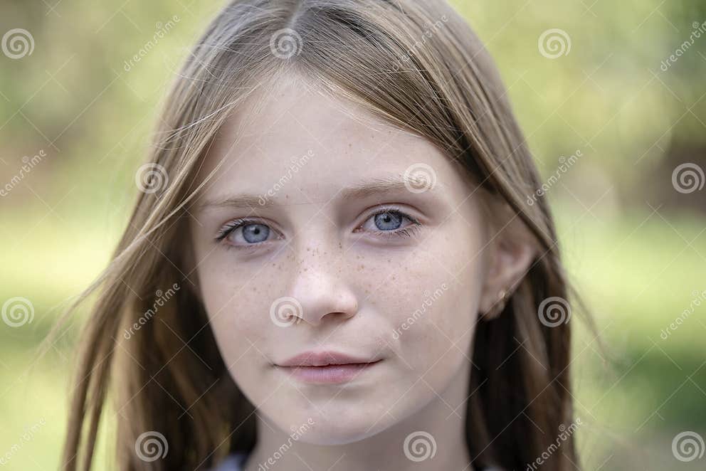 Beautiful Blond Young Girl With Freckles Outdoors On Nature Background