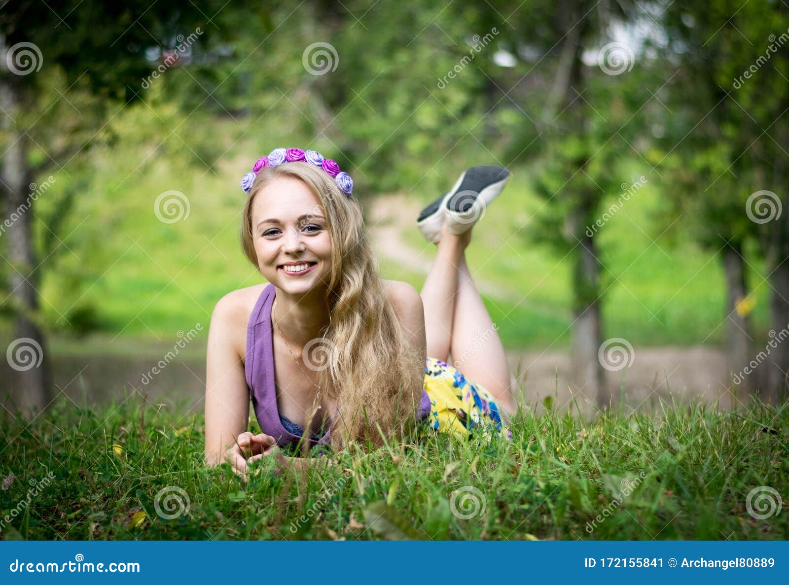 Beautiful Blonde Girl Is Lying In The Grass And Laughing Stock Image