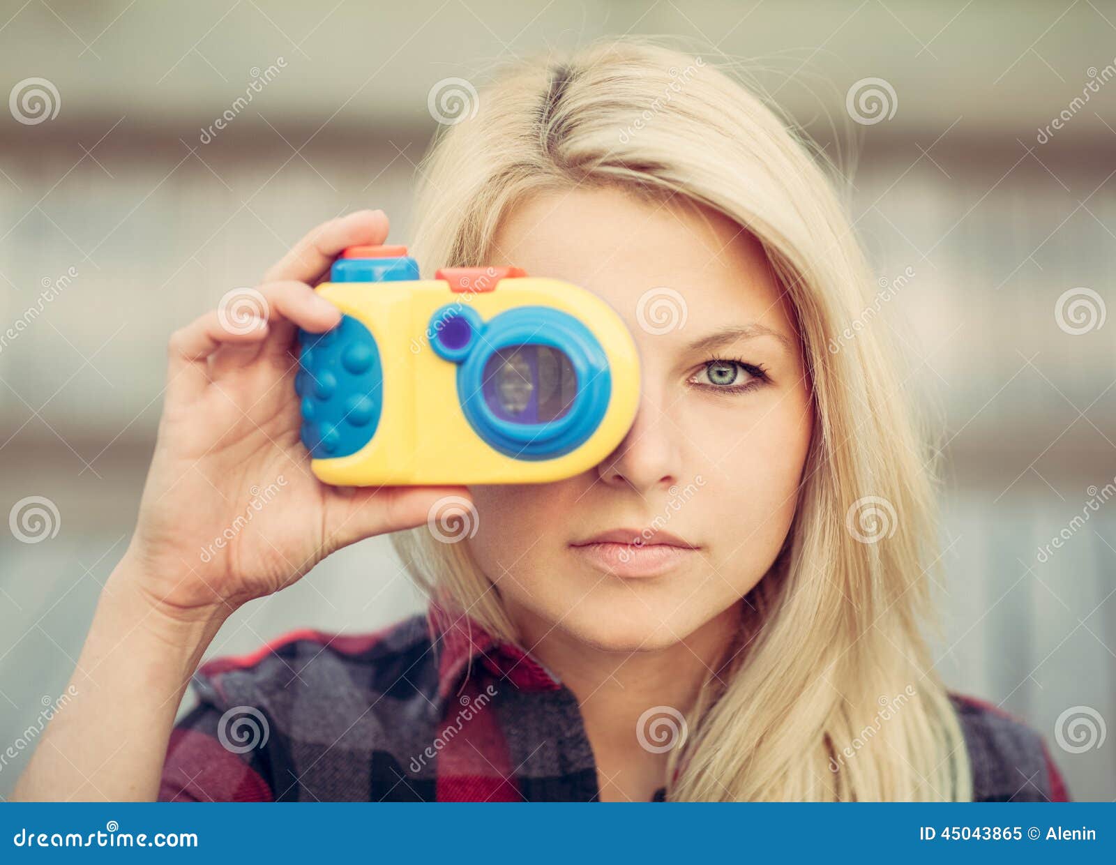 Beautiful Blonde With Long Hair Looking At The Camera And Holding In