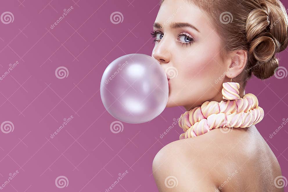 Beautiful Blonde Woman Blowing Pink Bubble Gum Fashion Portrait Stock