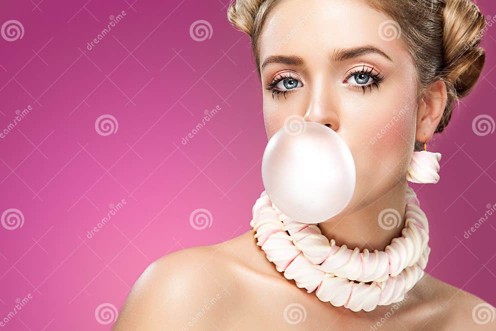 Beautiful Blonde Woman Blowing Pink Bubble Gum Fashion Portrait Stock