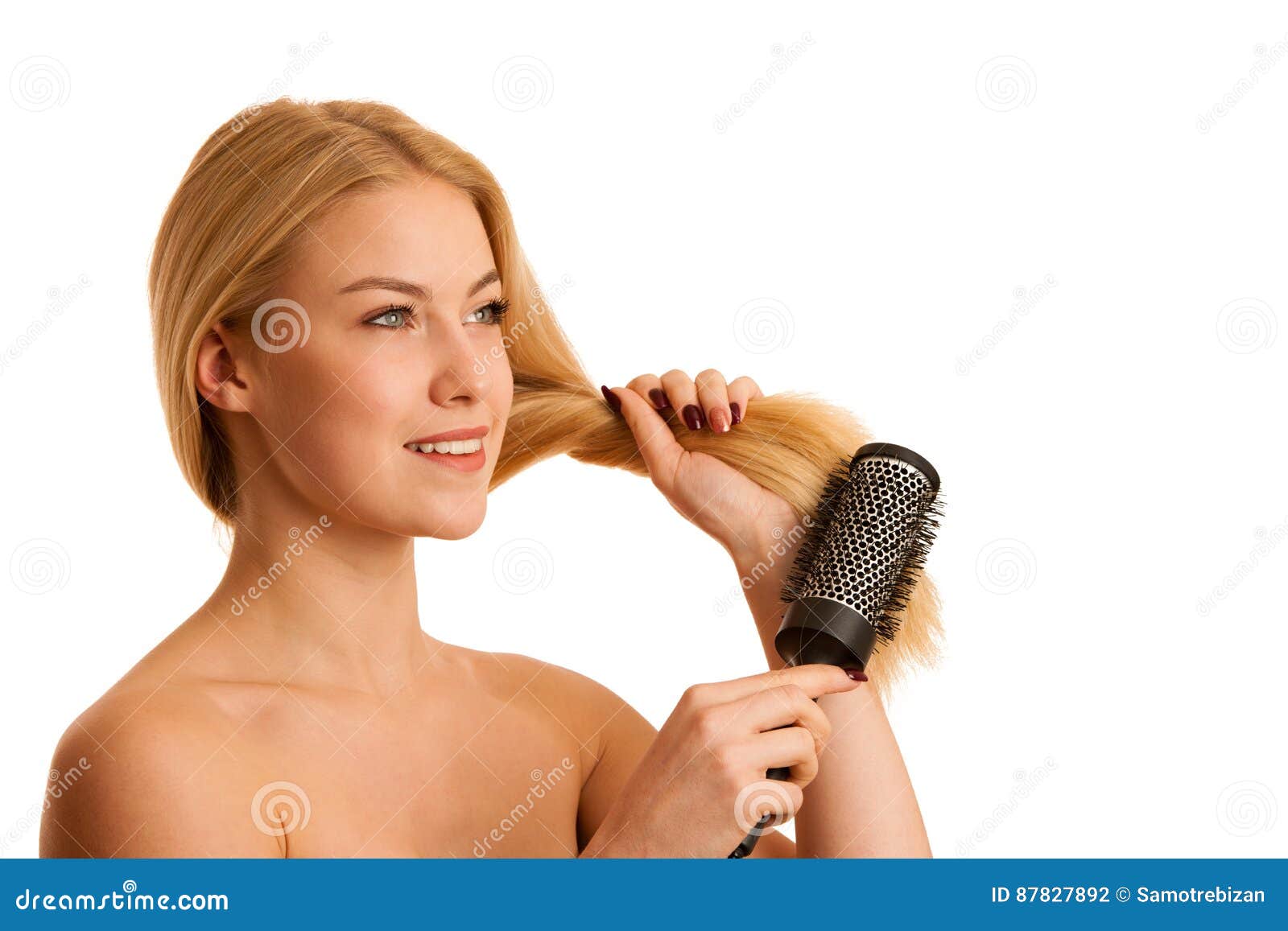 Beautiful Blonde Woman Brushing Her Hair As A Sign Og Hair Care Stock