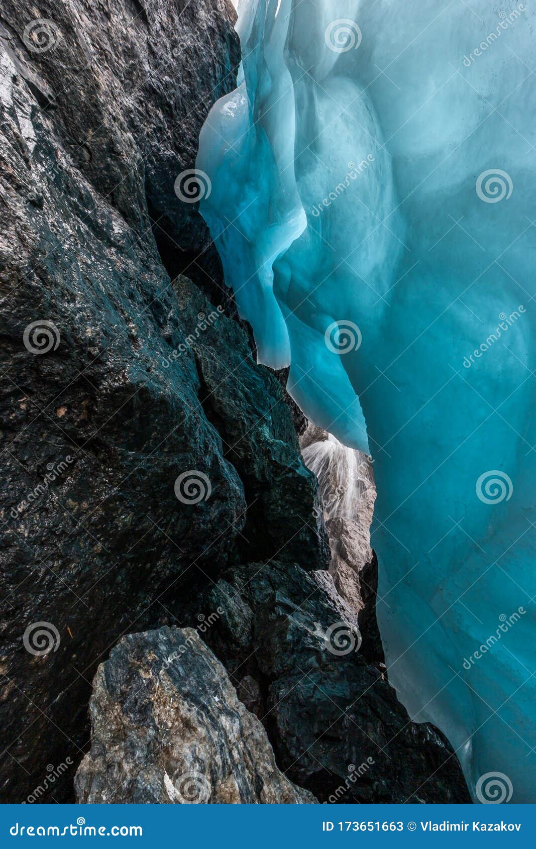 Beautiful Blue Ice Next To Water Flowing Over Large Stones. Stock Image ...