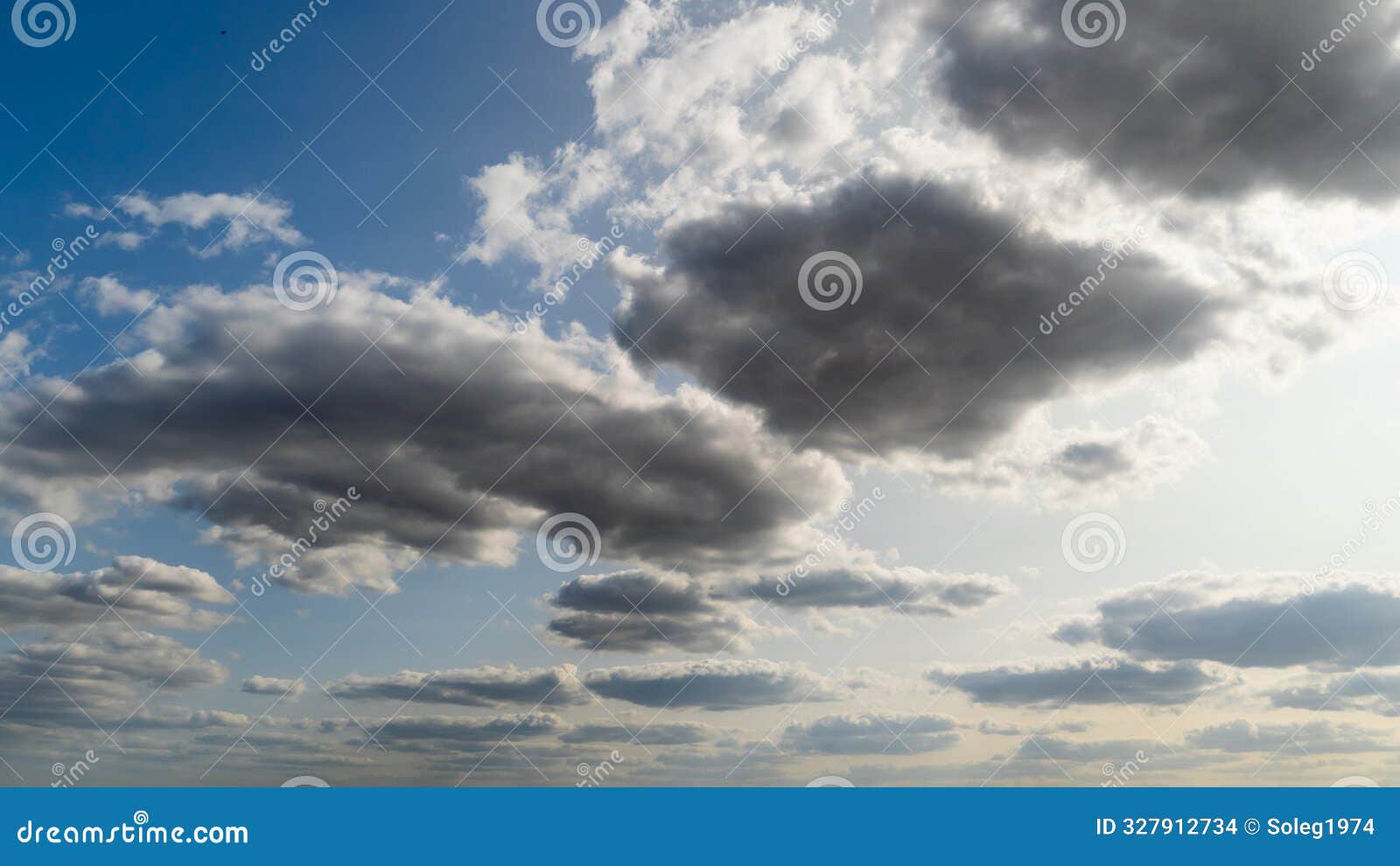 Beautiful Blue Sky with Dark Dramatic Cumulus Clouds and Sunlight for ...