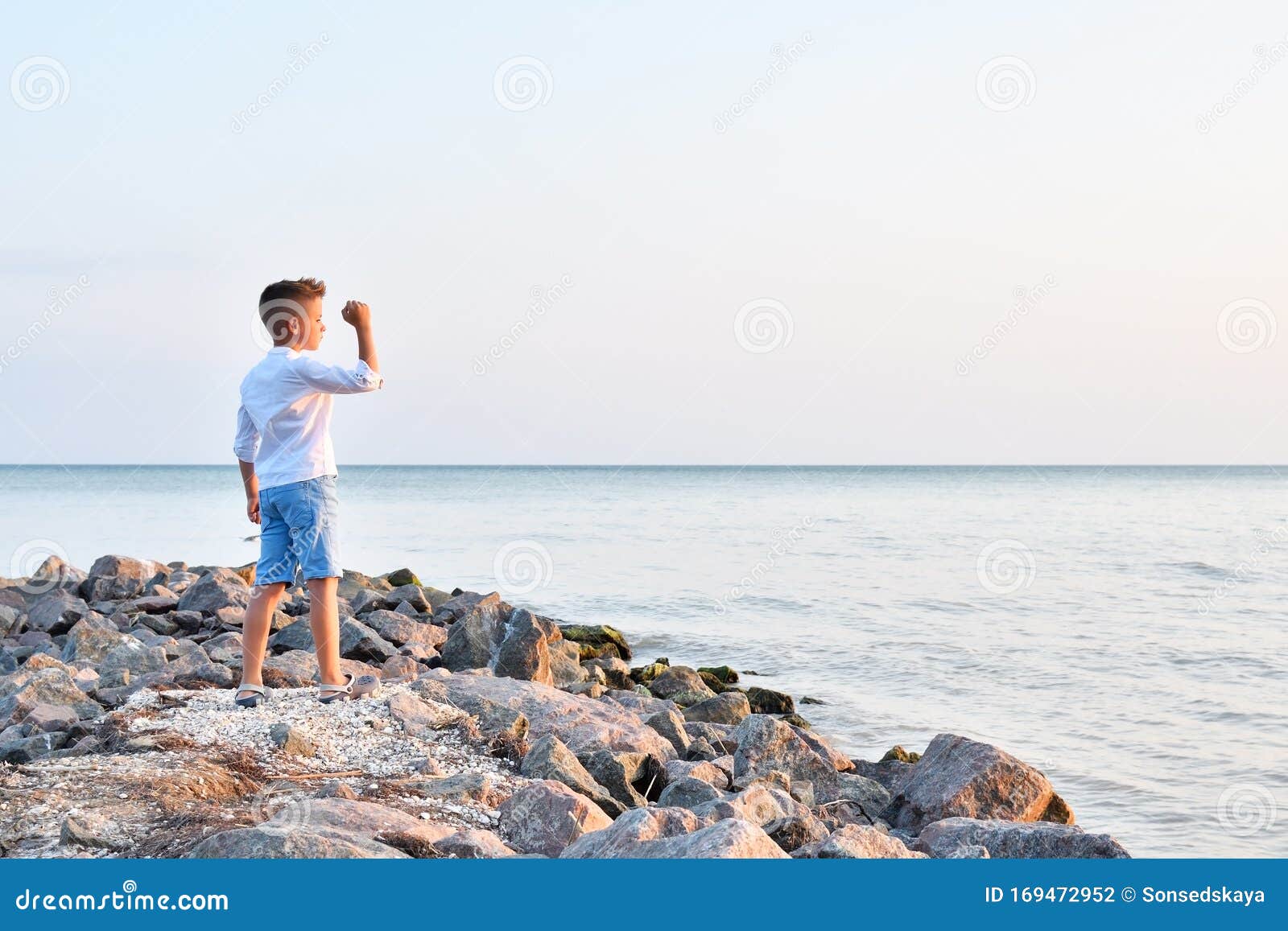 Beautiful Boy on the Seashore Watching the Sunset Stock Photo - Image ...