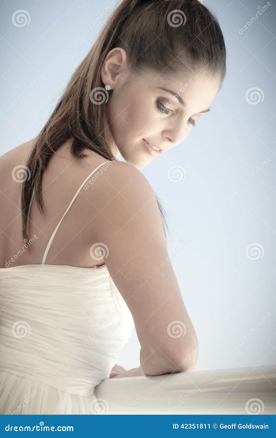 Beautiful Bride Looking Down Her Arm with Blue Background Stock Image ...