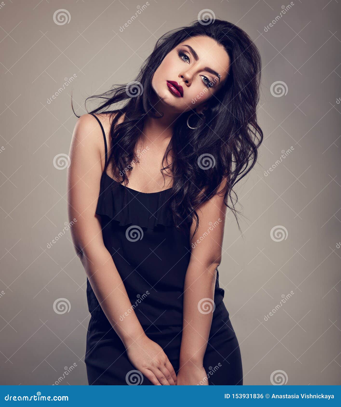 Beautiful Bright Makeup Woman With Long Black Curly Hair Style In Black