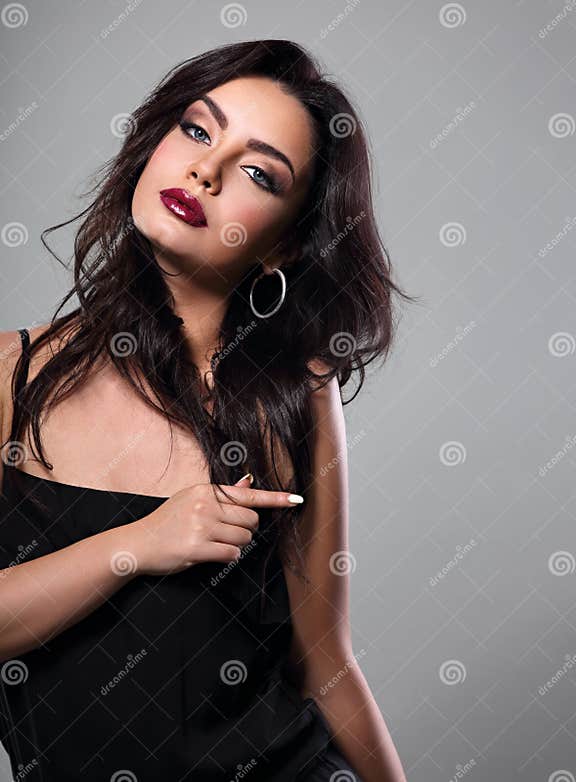 Beautiful Bright Makeup Woman With Long Black Curly Hair Style In Black