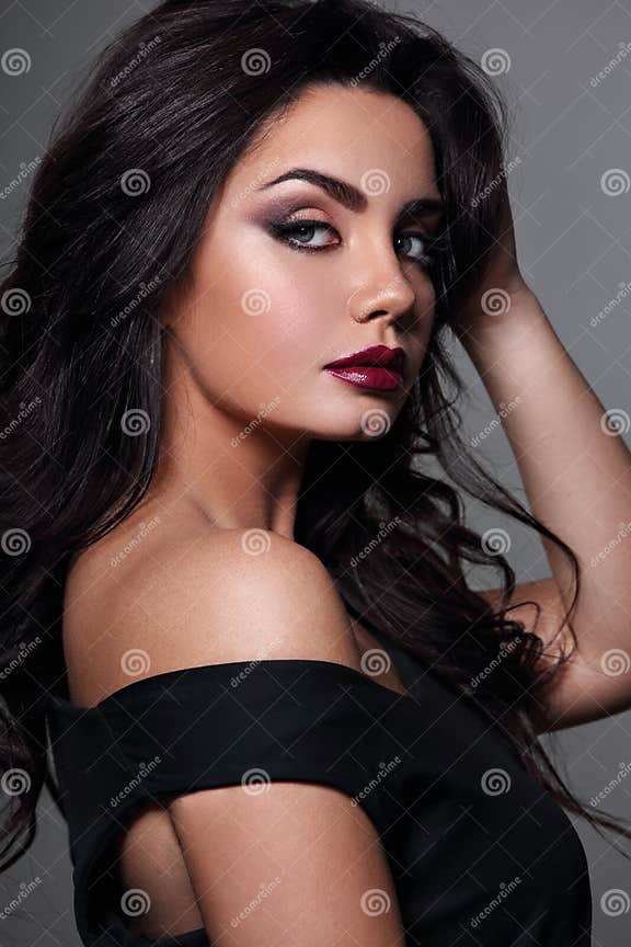 Beautiful Bright Makeup Woman With Long Black Curly Hair Style