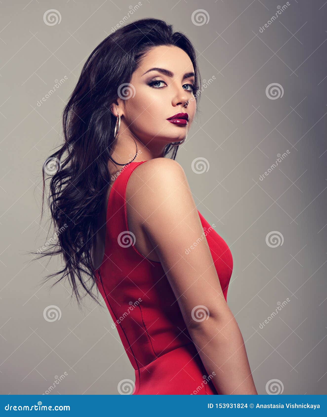 Beautiful Bright Makeup Woman With Long Black Curly Hair Style In Red