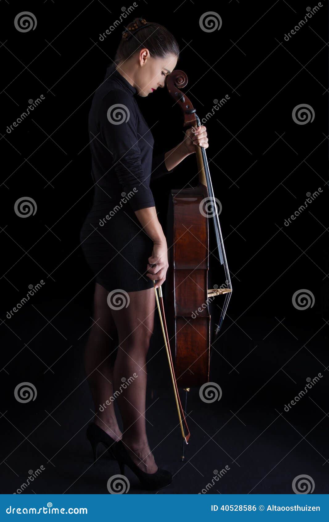 Beautiful Brunette Holding Cello with Selective Light in Black D Stock ...