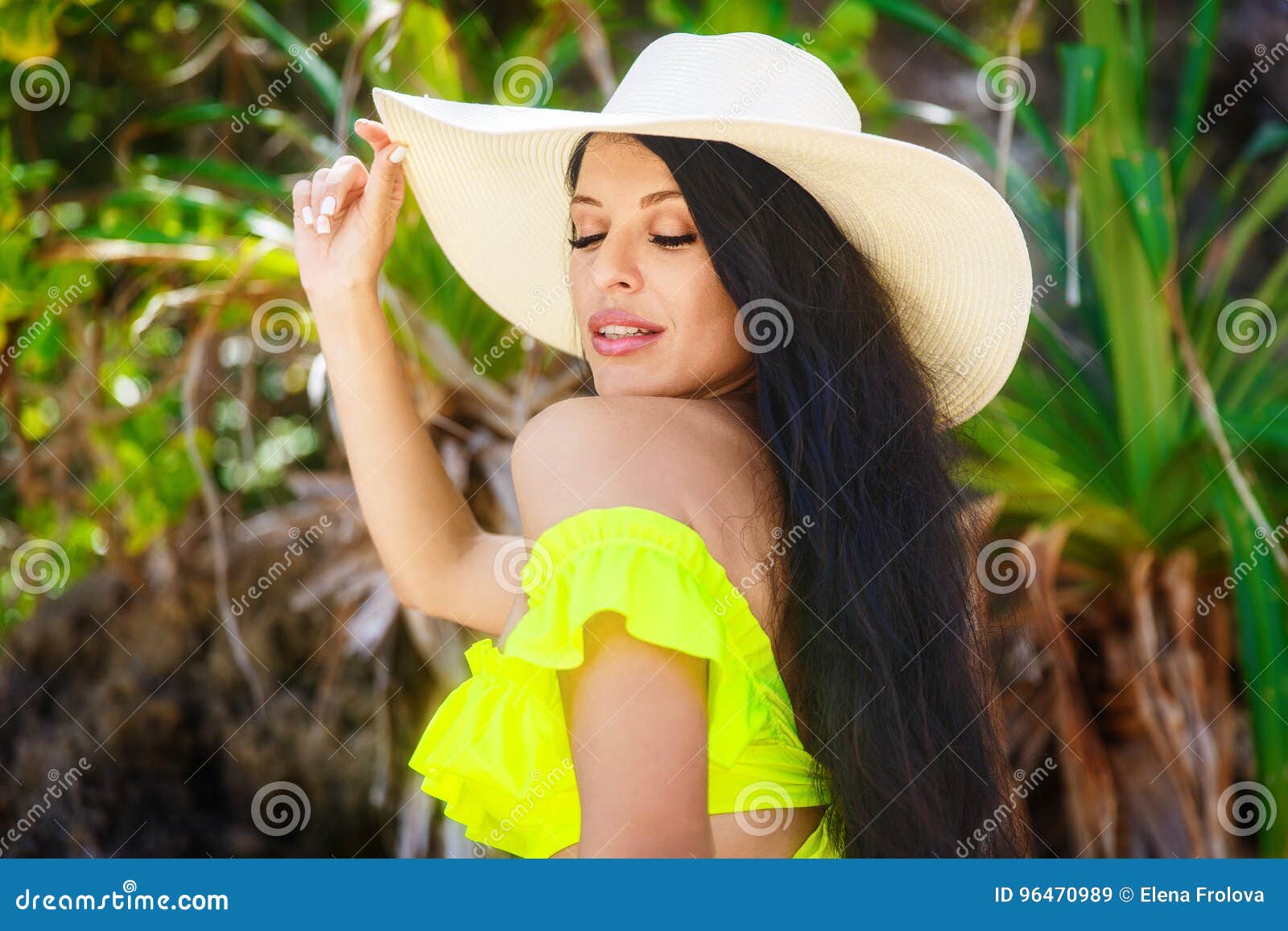 Beautiful Brunette With Long Hair In Bikini And Straw Hat On The Stock