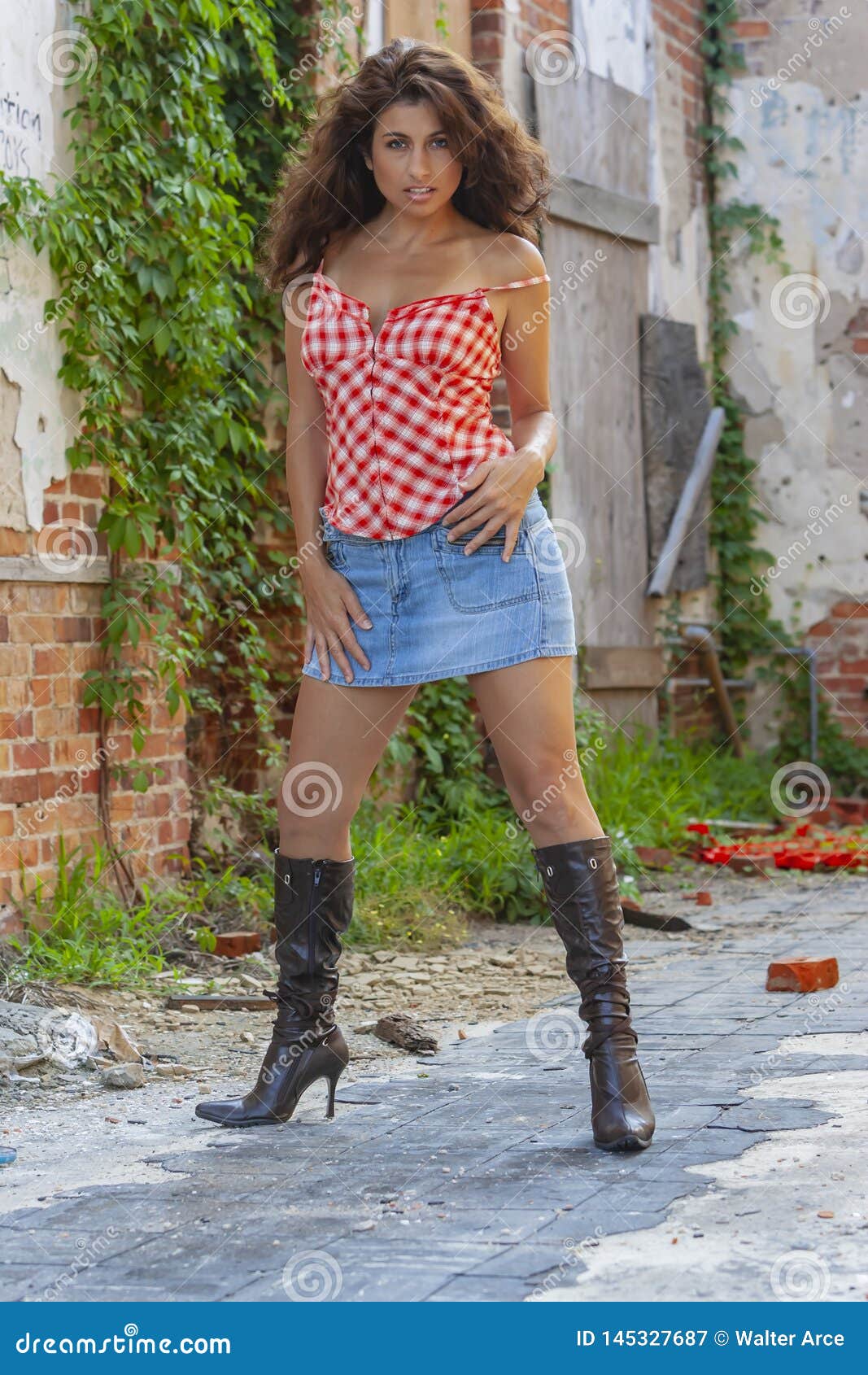 A Lovely Brunette Model Posing Outdoors With The Latest Fashions Stock