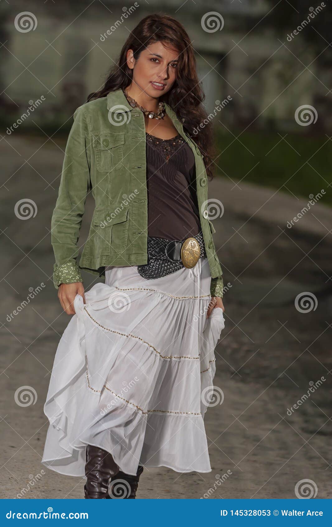 A Lovely Brunette Model Posing Outdoors With The Latest Fashions Stock