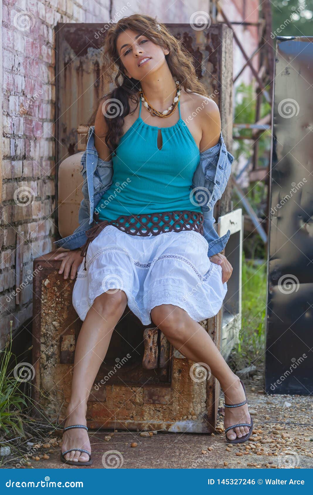 A Lovely Brunette Model Posing Outdoors With The Latest Fashions Stock