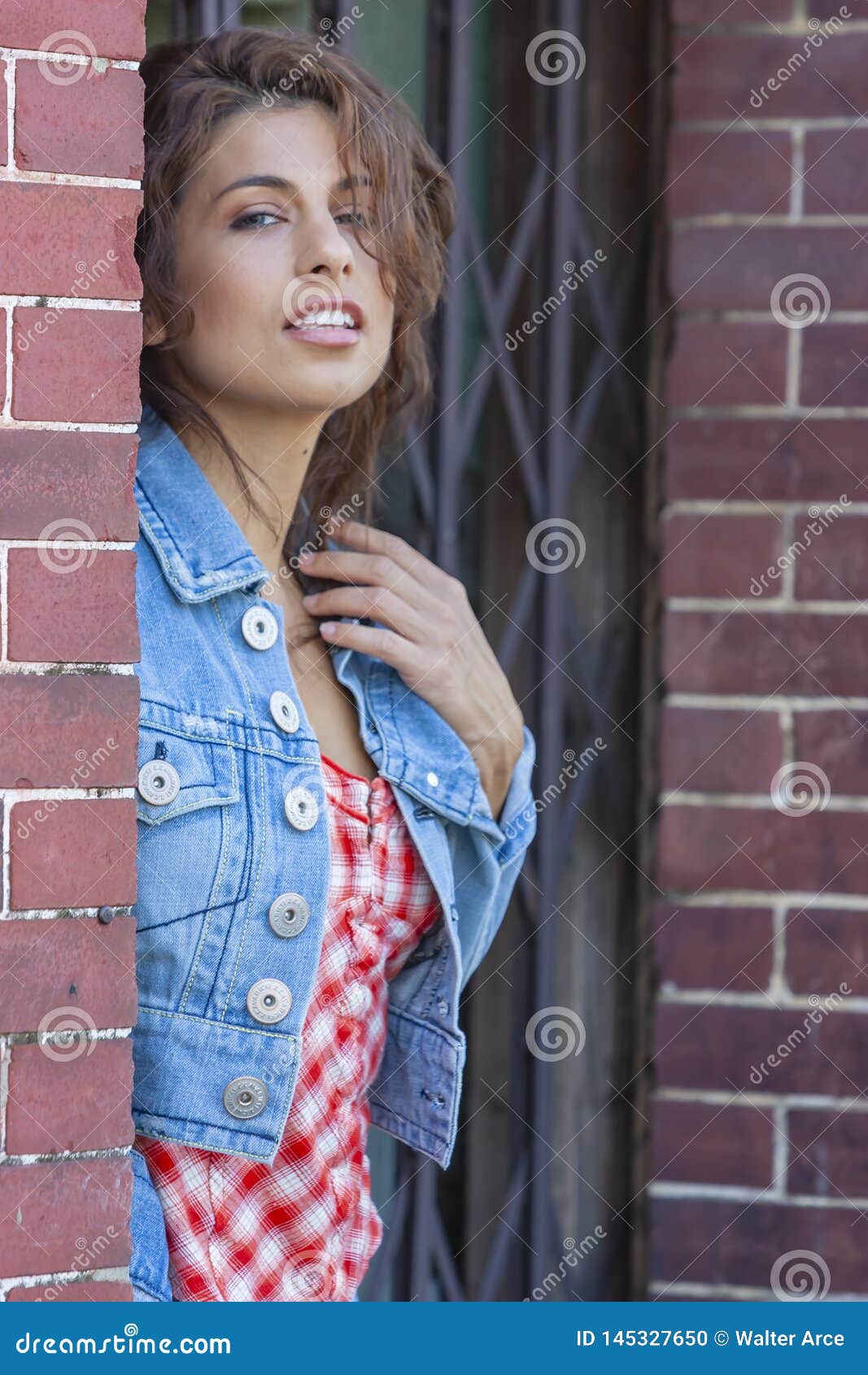 A Lovely Brunette Model Posing Outdoors With The Latest Fashions Stock