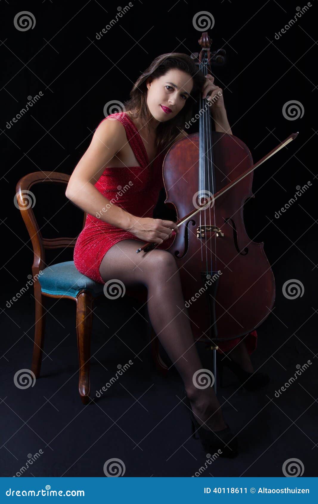 Beautiful Brunette Playing Cello with Selective Light in Red Dress ...