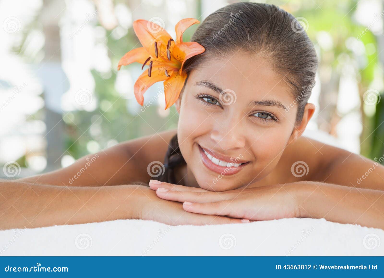 Beautiful Brunette Relaxing On Massage Table Smiling At Camera Stock