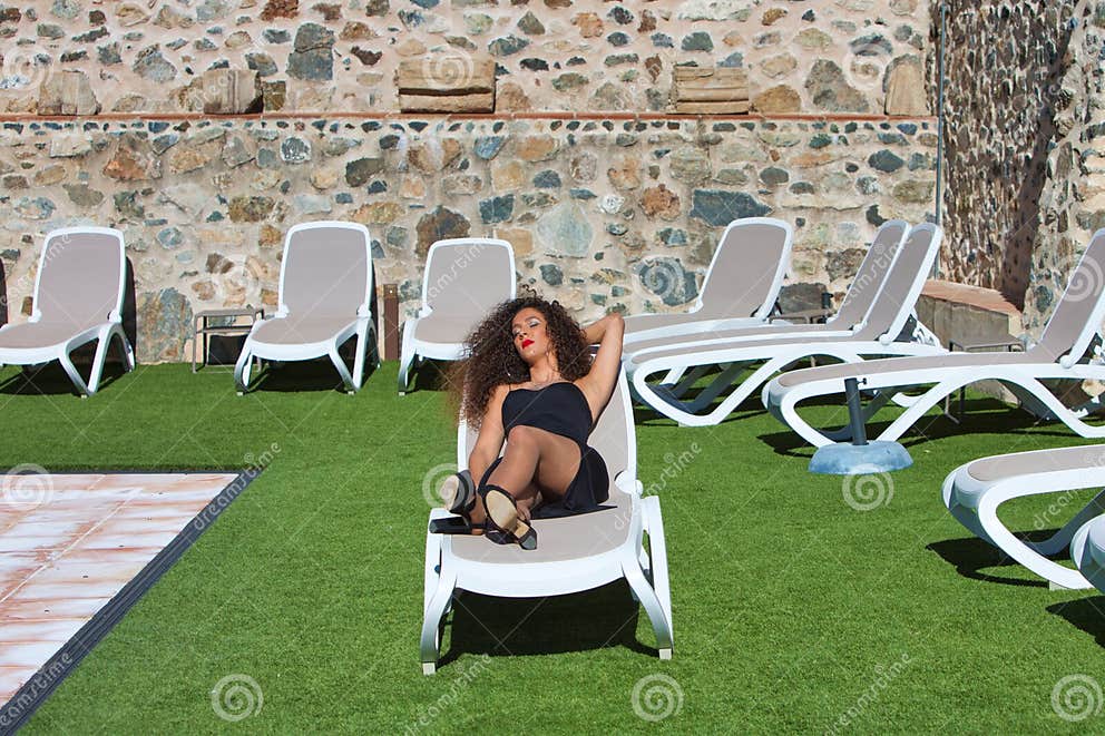 Beautiful Brunette Woman Dressed In Black Summer Suit Relaxing On Sun
