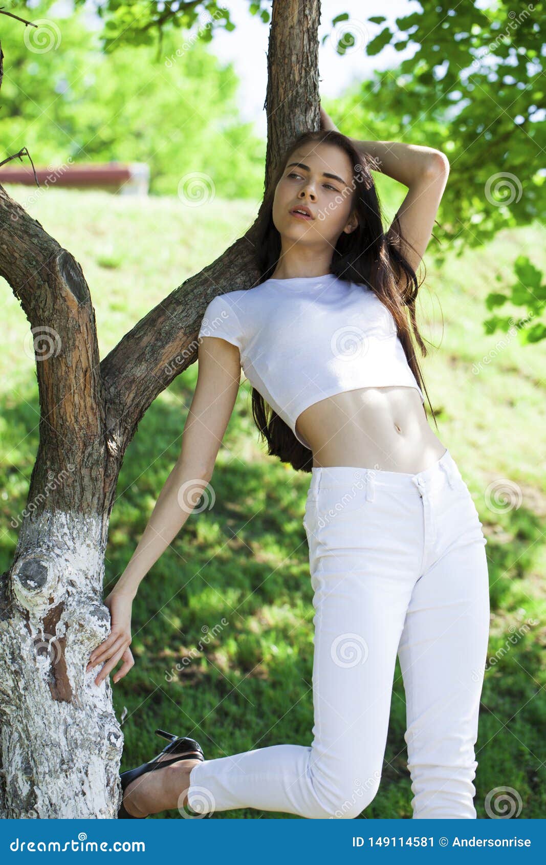 Beautiful Brunette Woman Posing Against Summer Park Bright Sunny