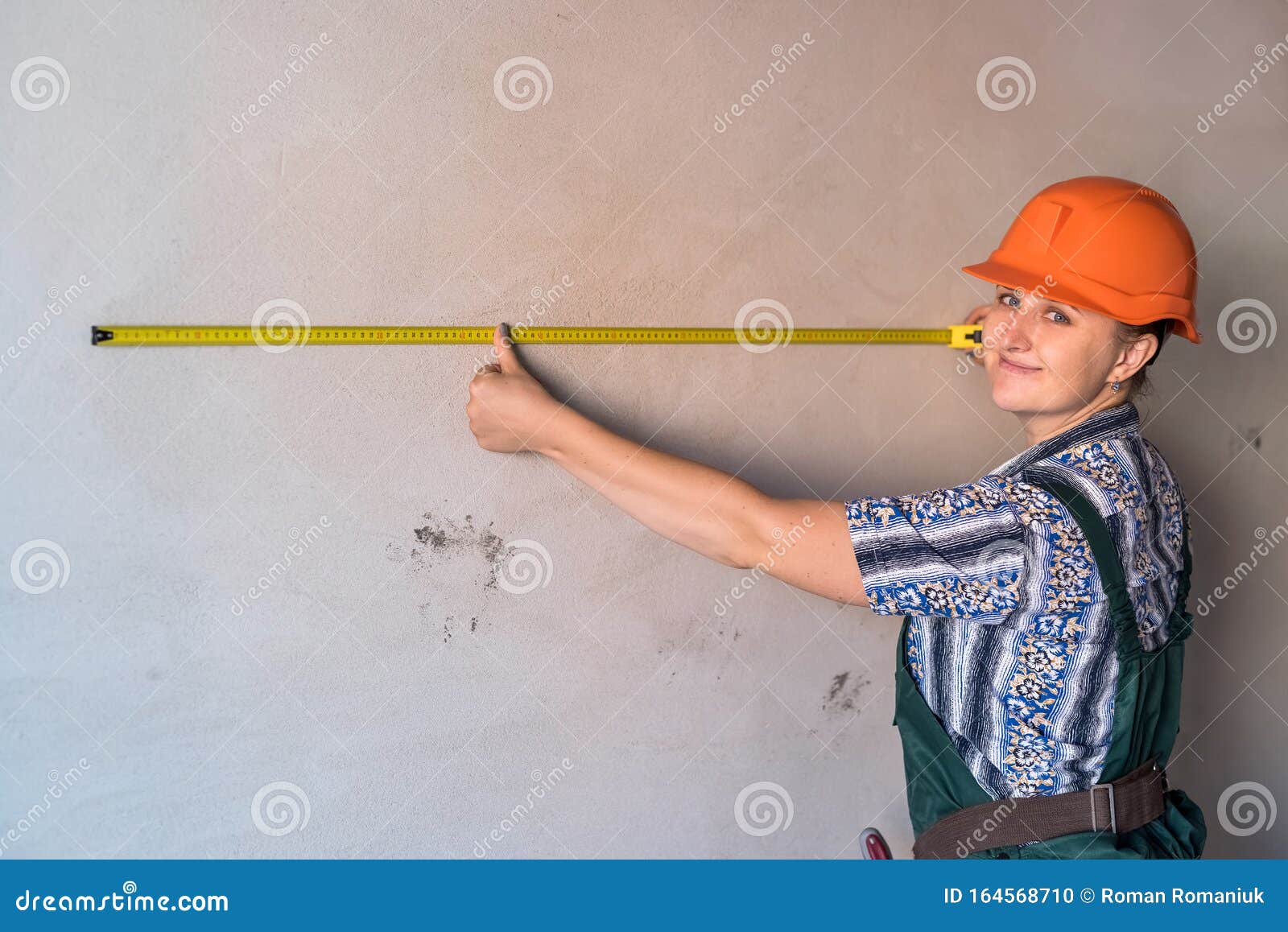 Beautiful Builder with Measuring Tape in New Apartment Stock Photo ...