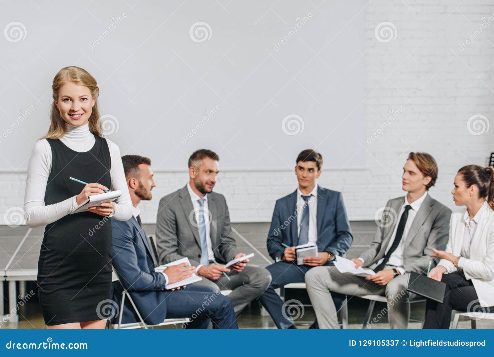Beautiful Business Coach Standing in Front of Businesspeople at ...