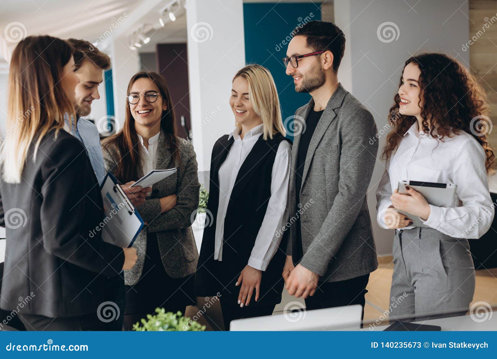 Beautiful Business People are Using Gadgets, Talking and Smiling during ...