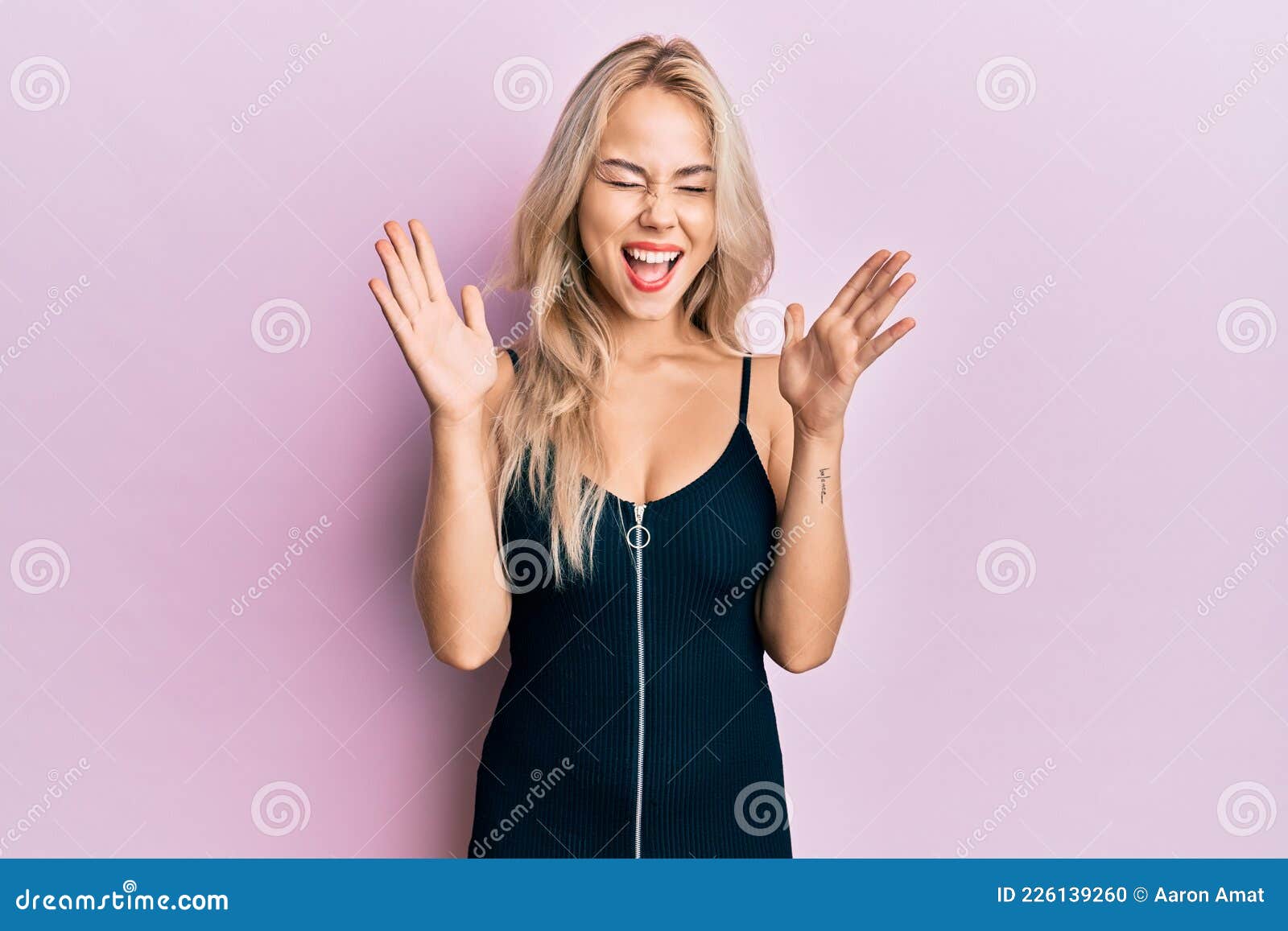 Beautiful Caucasian Blonde Girl Wearing Party Dress Celebrating Mad And