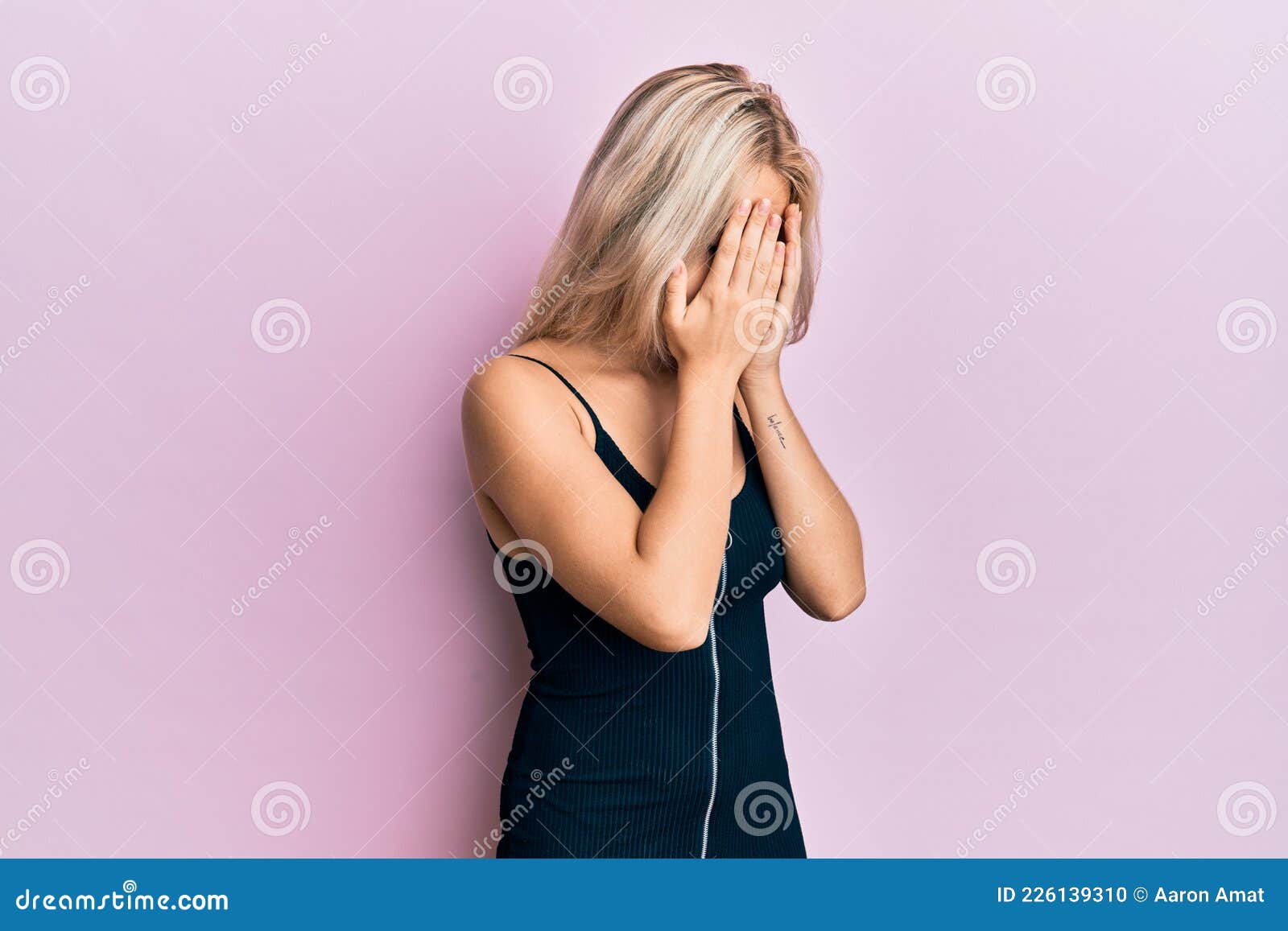 Beautiful Caucasian Blonde Girl Wearing Party Dress With Sad Expression