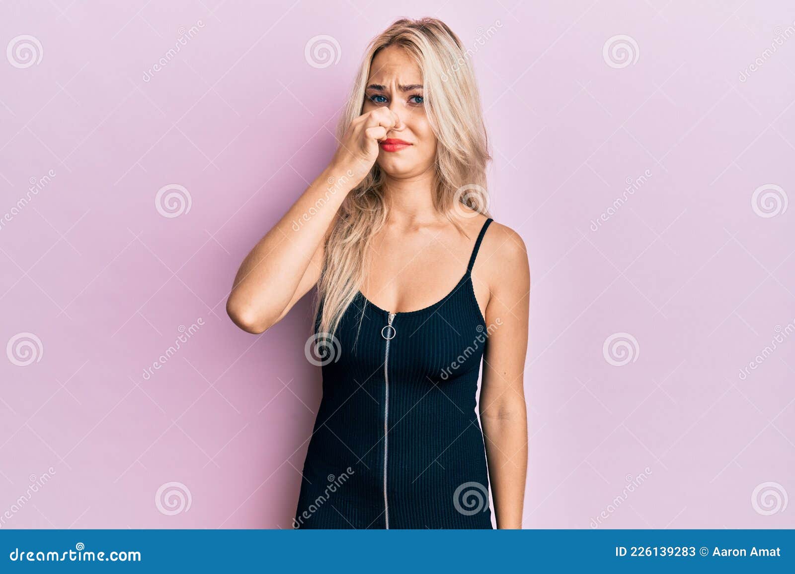 Beautiful Caucasian Blonde Girl Wearing Party Dress Smelling Something