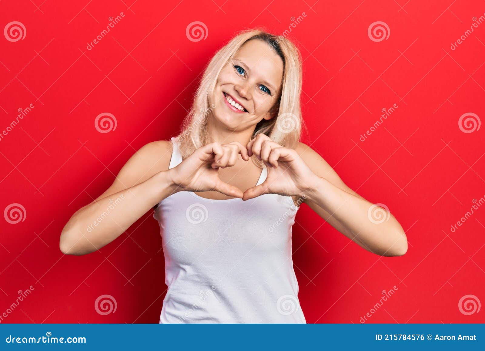 Beautiful Caucasian Blonde Woman Wearing Casual White T Shirt Smiling