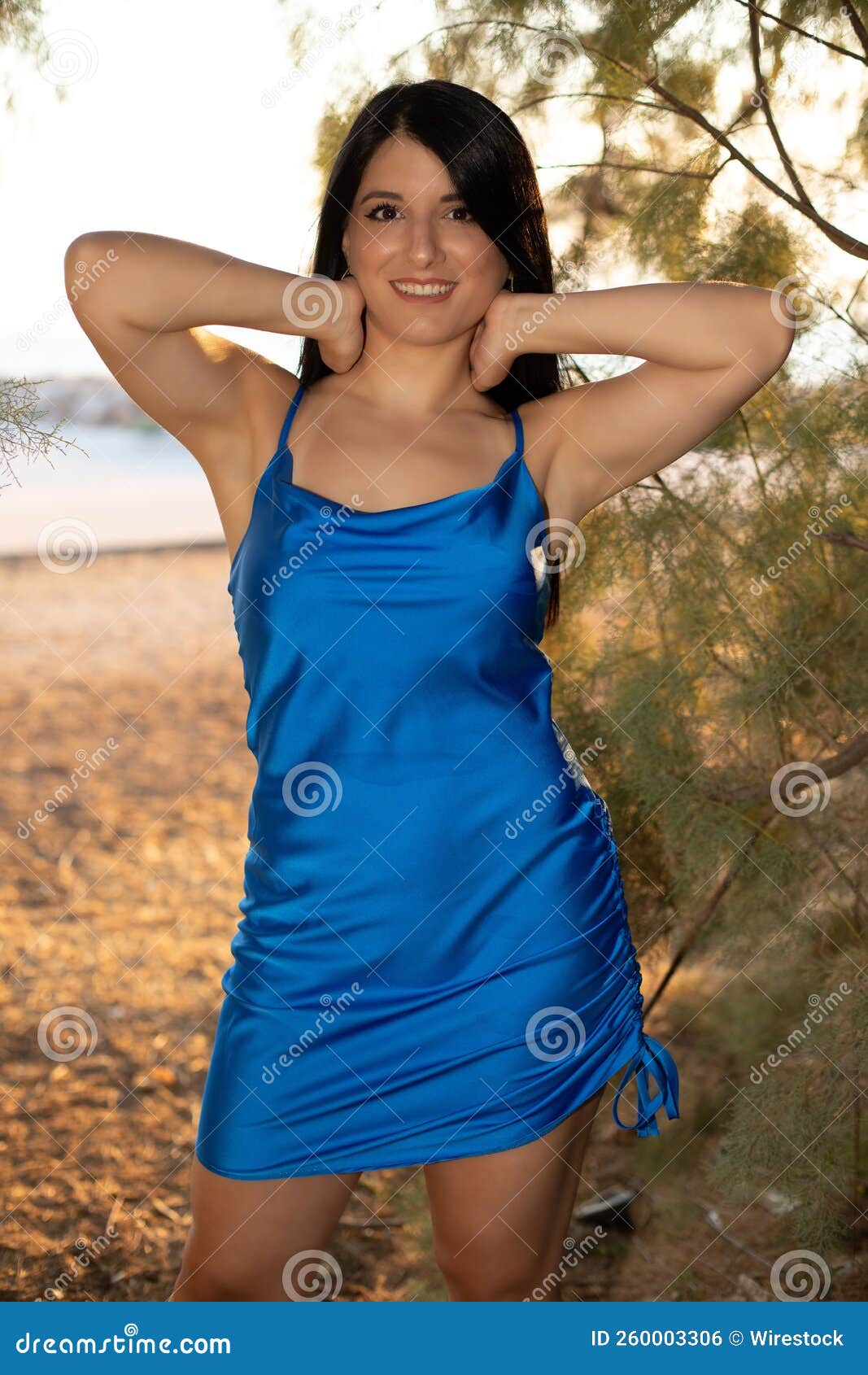 Beautiful Caucasian Girl In Short Blue Dress Posing Outside On The