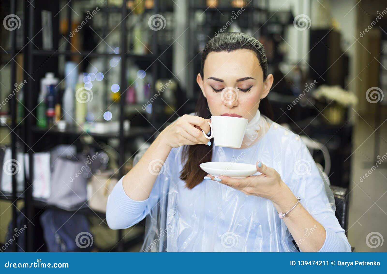 Beautiful Cheerful Female Client Drinking a Cup of Coffee in Beauty ... Beautiful Cheerful Female Client Drinking a Cup of Coffee in Beauty ...
