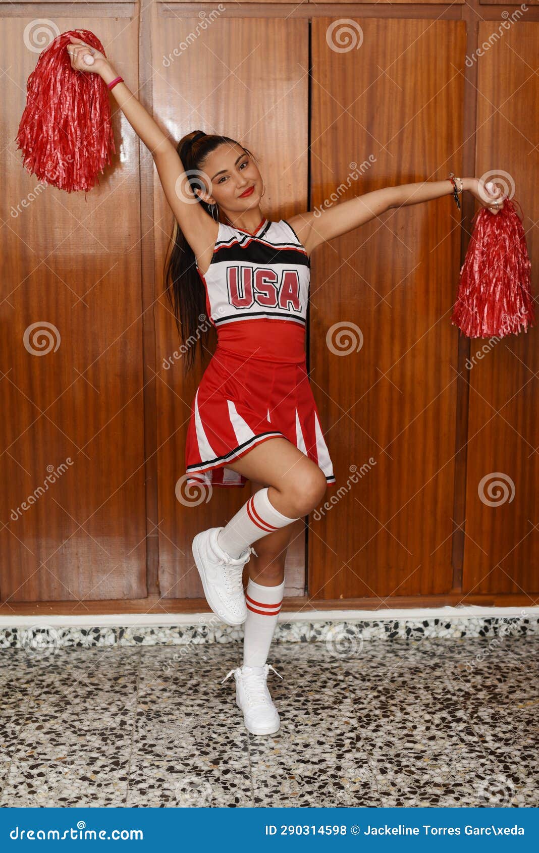 A Beautiful Cheerleader Dressed in a Red Uniform Stock Photo - Image of ...