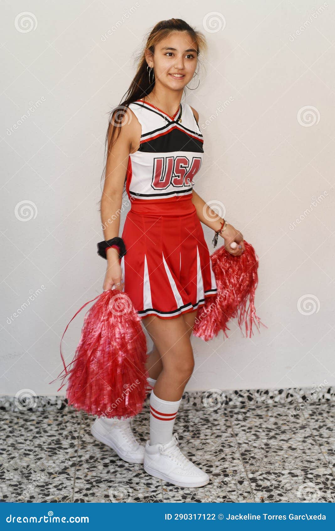A Beautiful Cheerleader Dressed in a Red Uniform Stock Photo - Image of ...