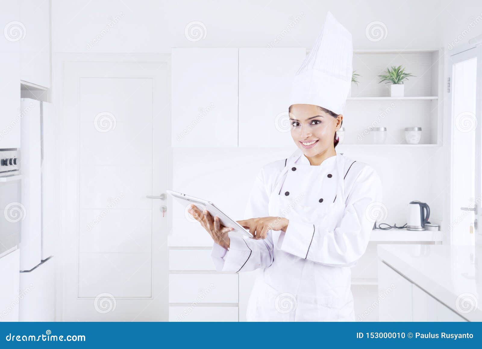 Beautiful Chef Using a Tablet in the Kitchen Stock Photo - Image of ...