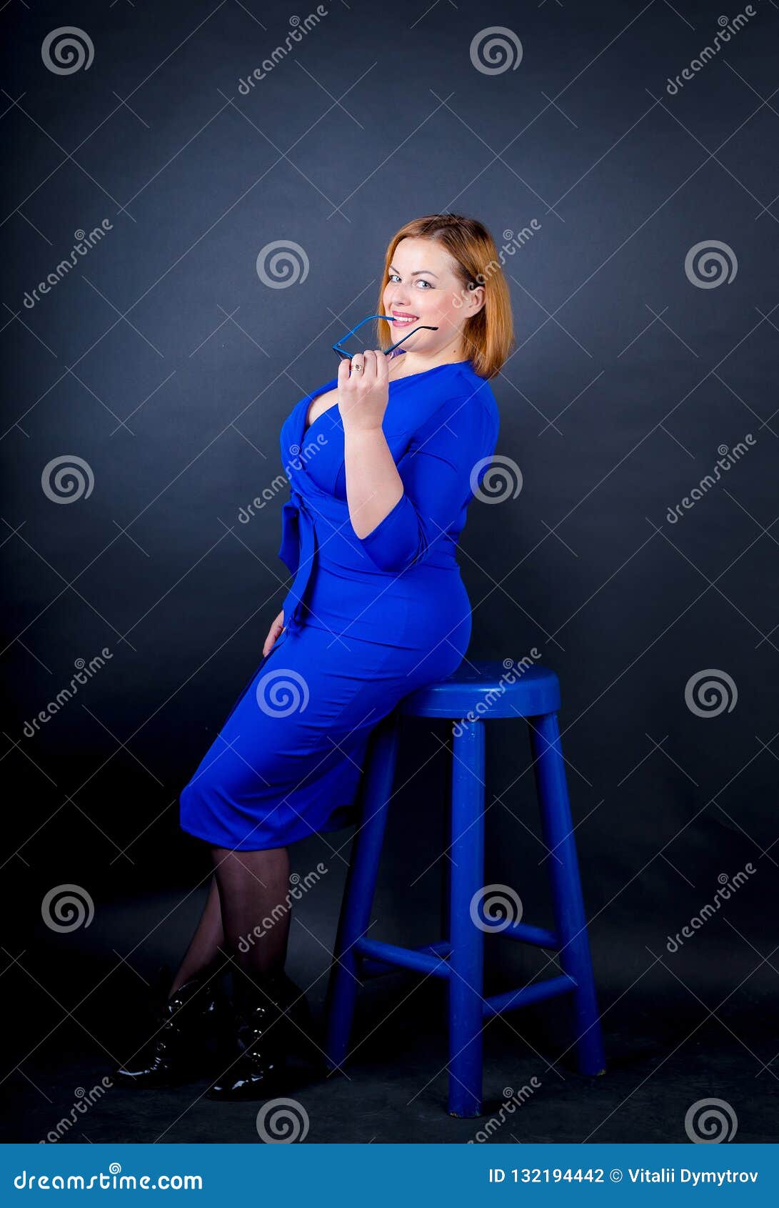 Beautiful Chubby Girl In Blue Elegant Dress On A Black Background