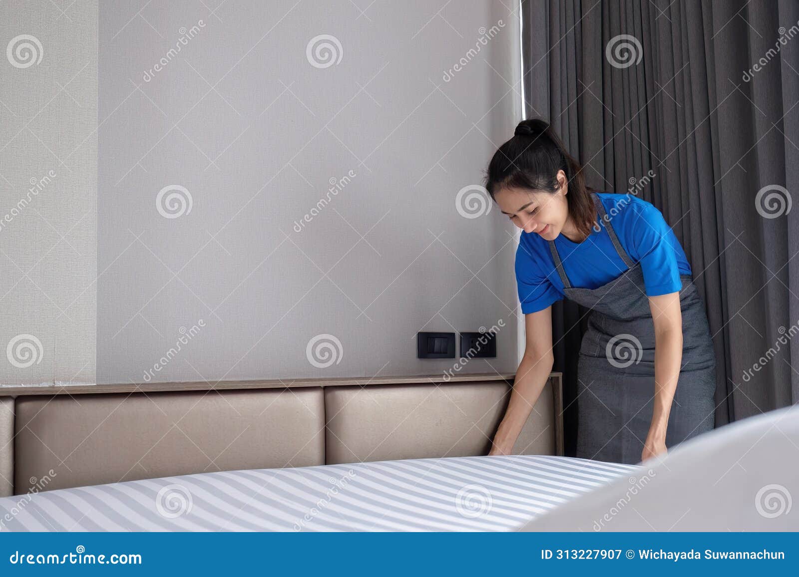 Beautiful Cleaning Lady Clean and Prepare the Bedding on the Bed ...