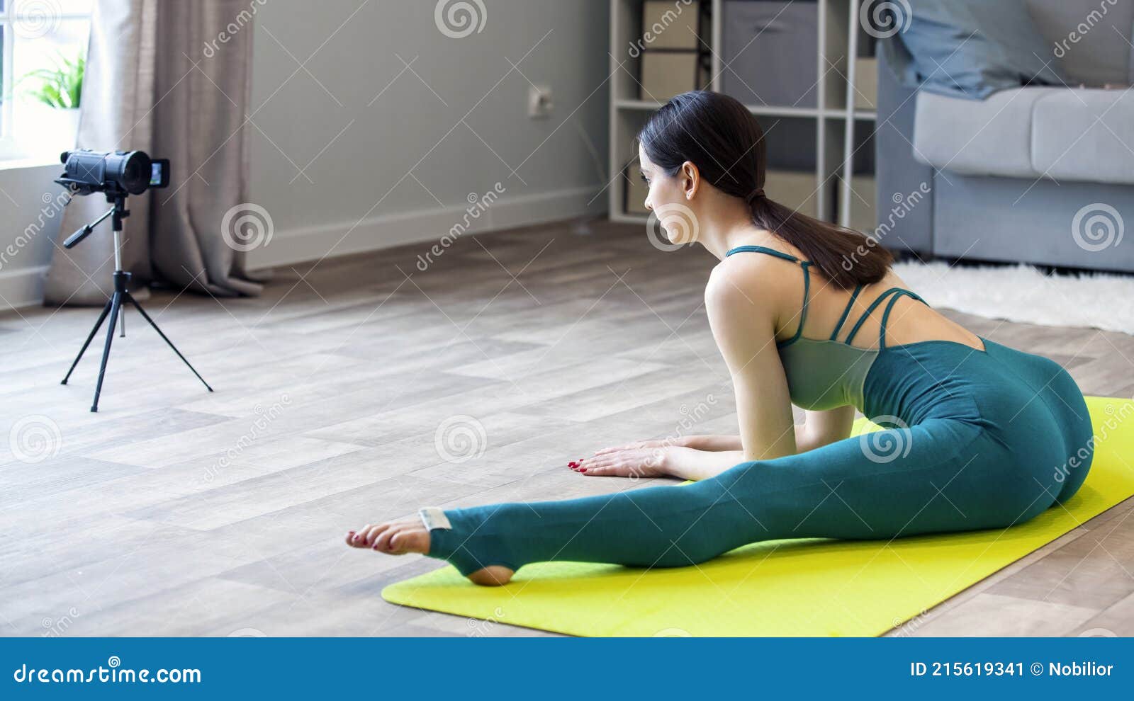 Coach Sitting on a Floor and Recording a Video Tutorial for Her ...