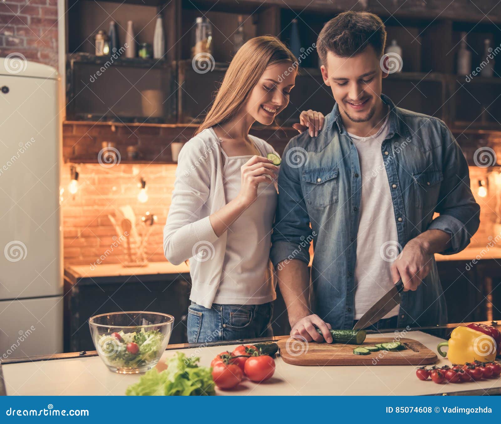 Beautiful couple cooking stock photo. Image of dinner - 85074608