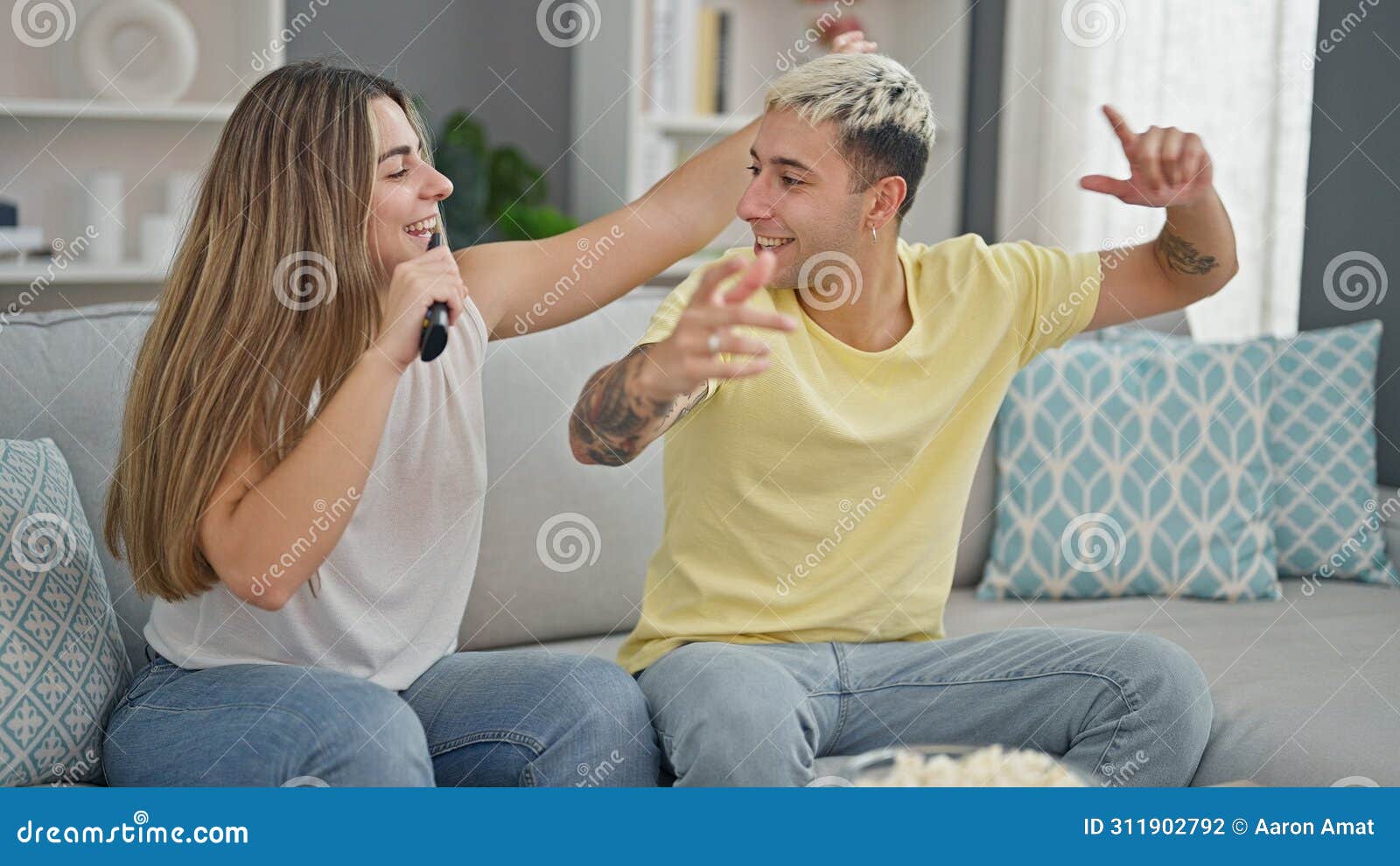 Beautiful Couple Singing Song Using Remote Control As a Microphone at ...