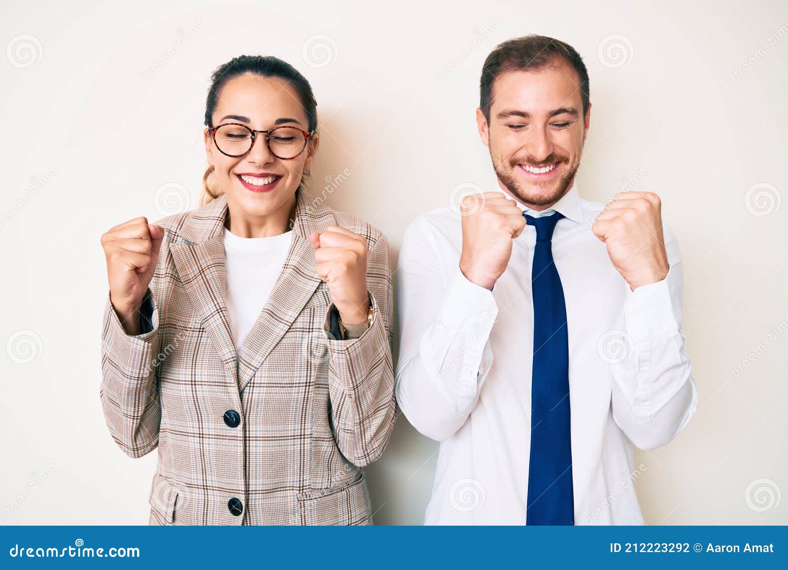 Beautiful Couple Wearing Business Clothes Excited For Success With Arms