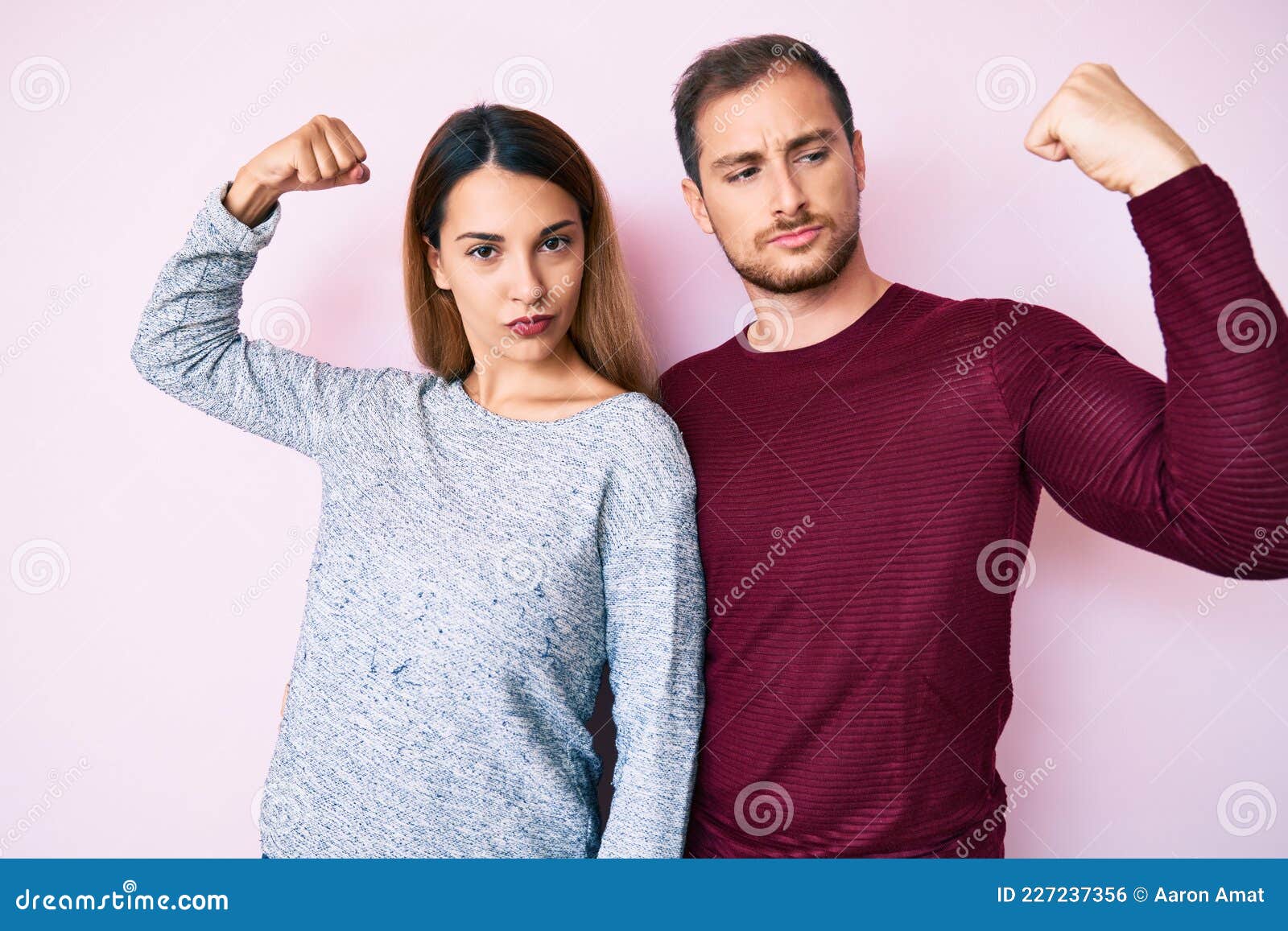 Beautiful Couple Wearing Casual Clothes Showing Arms Muscles Smiling