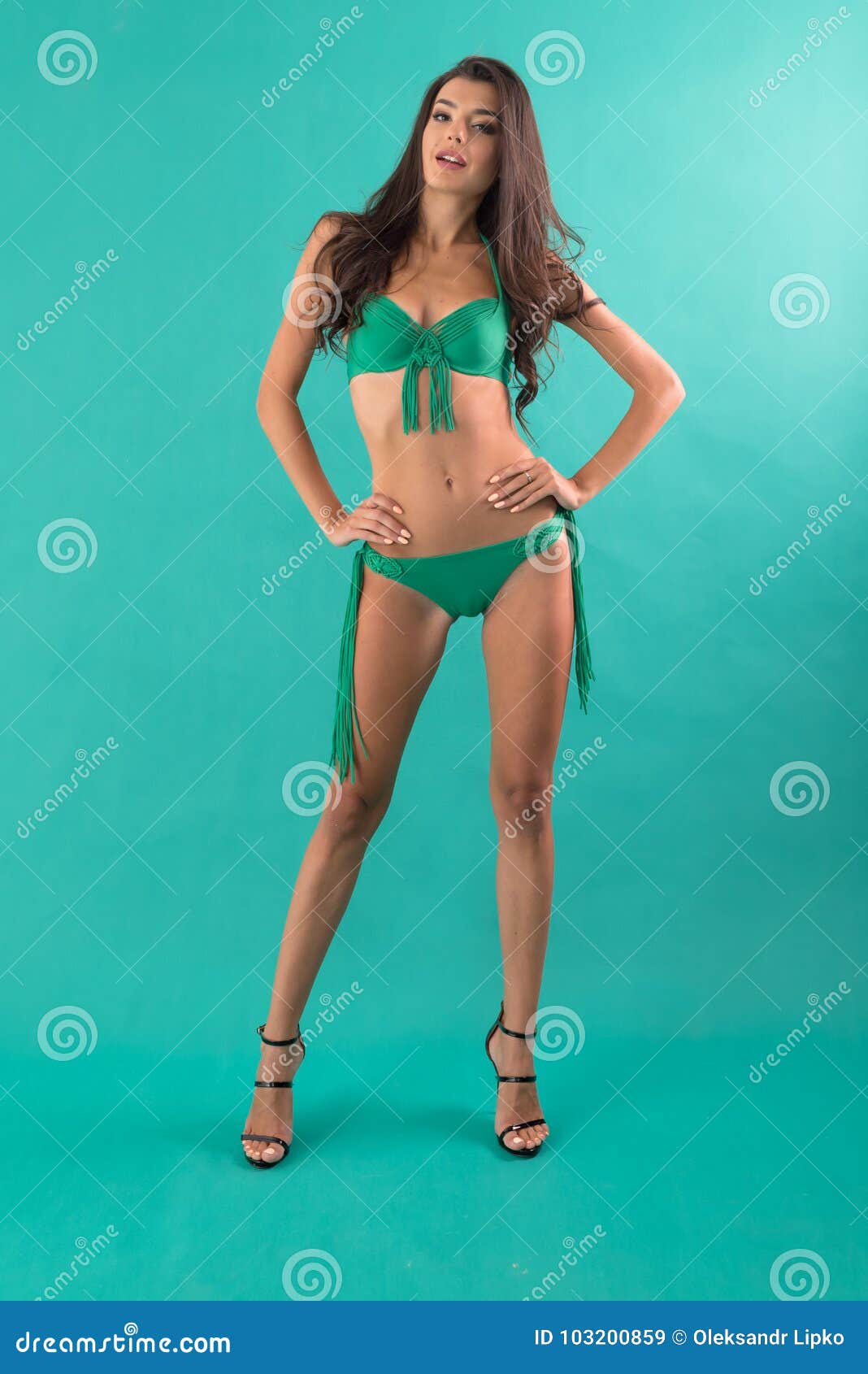 Beautiful Dark Haired Woman In A Green Swimsuit On A Green Background Stock Image Image Of