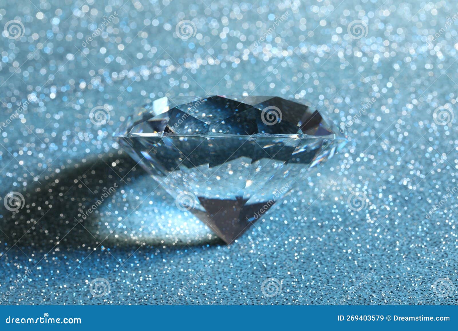 Beautiful Dazzling Diamond on Blue Glitter Background, Closeup Stock ...