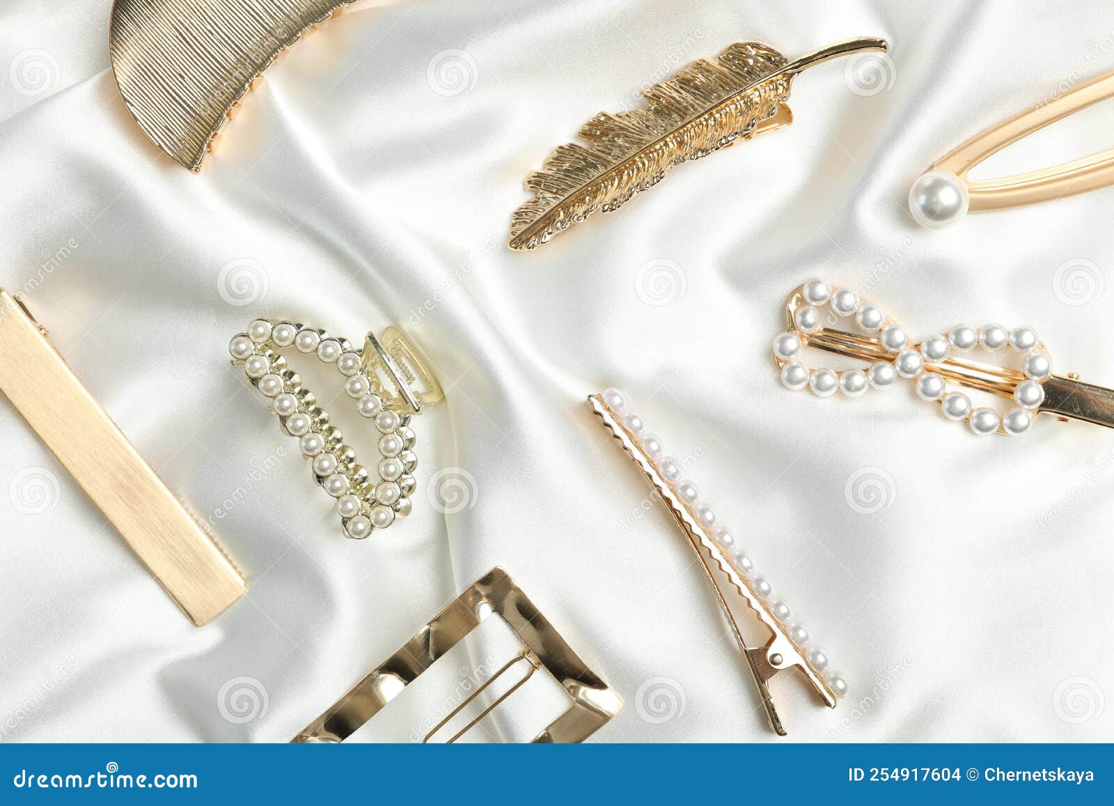 Beautiful Different Hair Clips on White Fabric, Flat Lay Stock Photo ...