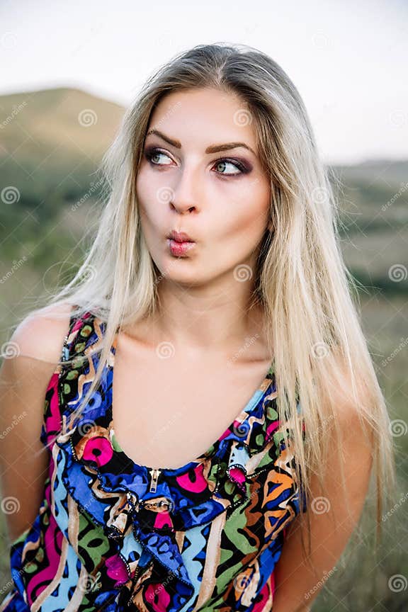 Beautiful Dreamy Blonde Girl With Blue Eyes In A Light Turquoise Dress