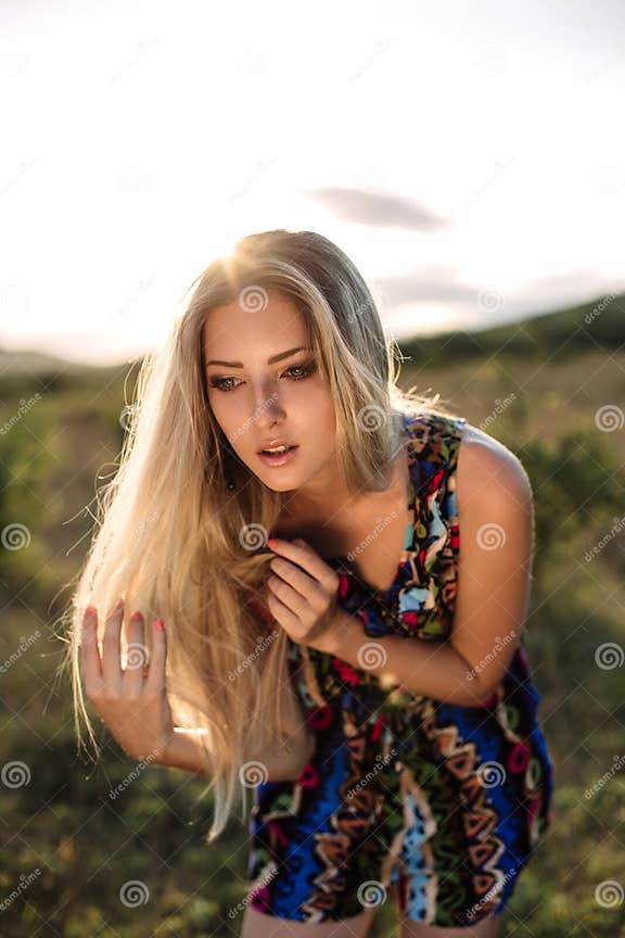 Beautiful Dreamy Blonde Girl With Blue Eyes In A Light Turquoise Dress